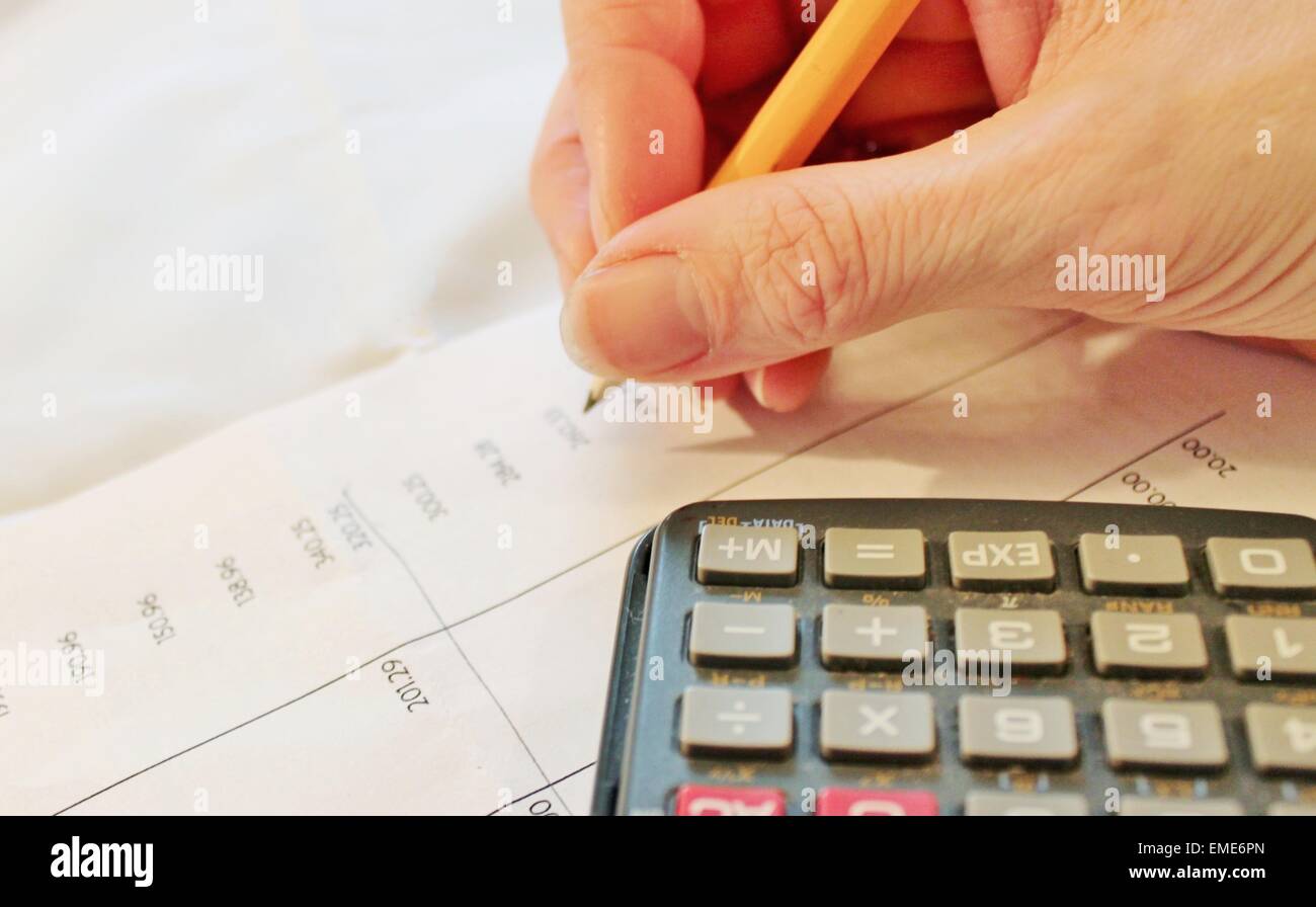 Bank statement with pencil and calculator Stock Photo - Alamy