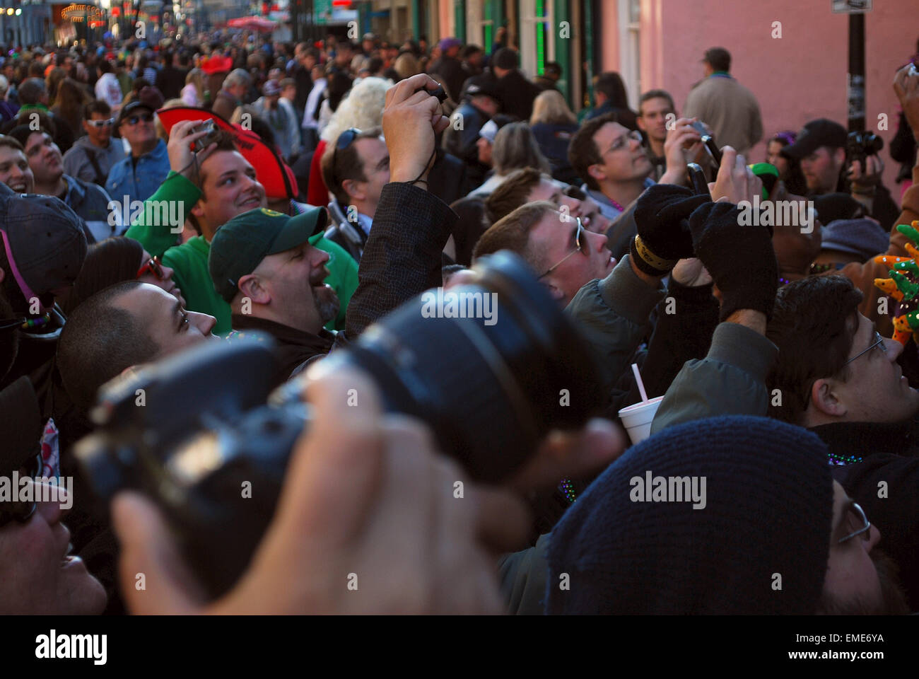 Crowds taking photos of bare breasted women on a balcony during Mardi ...