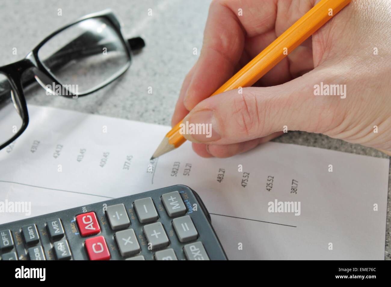 Bank statement with pencil and calculator Stock Photo - Alamy
