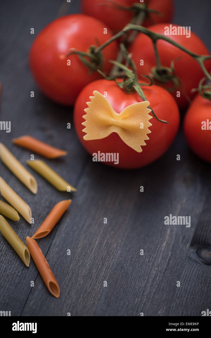 food background on rustic wood with pasta and tomatoes Stock Photo - Alamy
