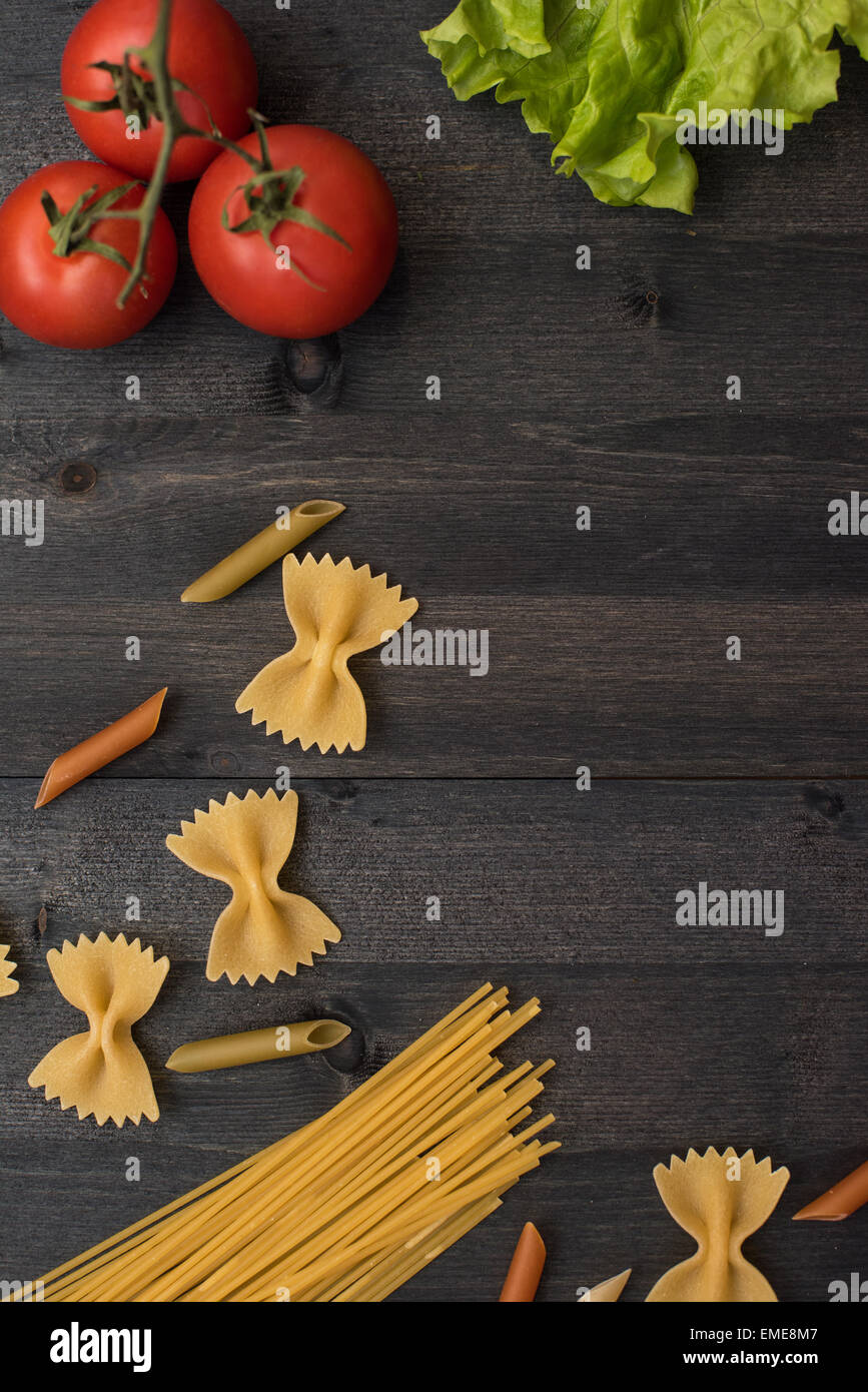 food background on rustic wood with pasta and tomatoes Stock Photo - Alamy