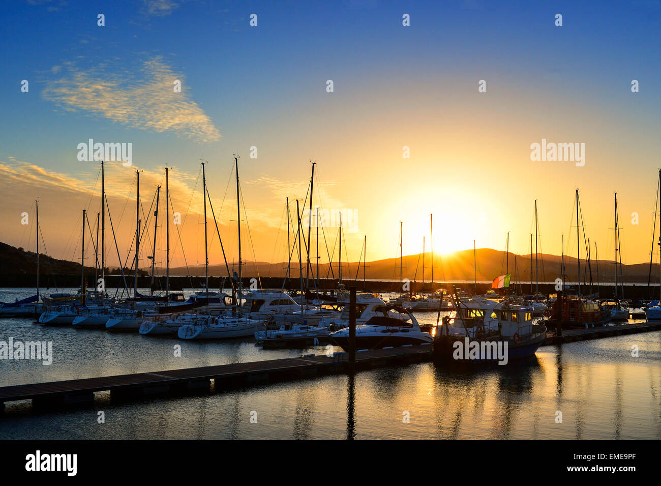 Setting sun over Fahan marina and Lough Swilly, Fahan, County Donegal ...