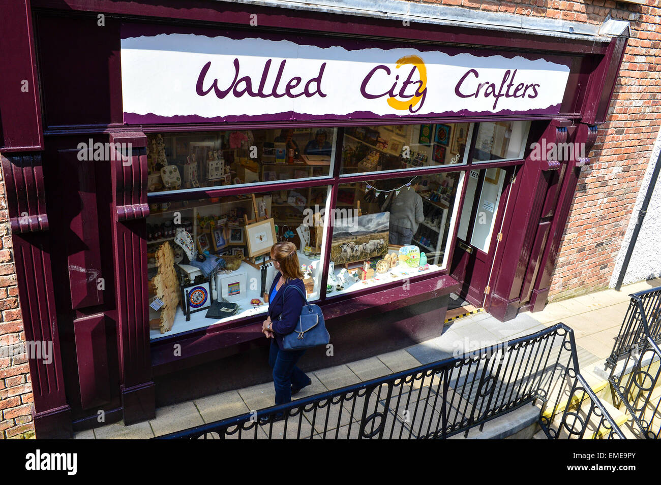 Woman looking at window display in craft shop, Craft Village ...
