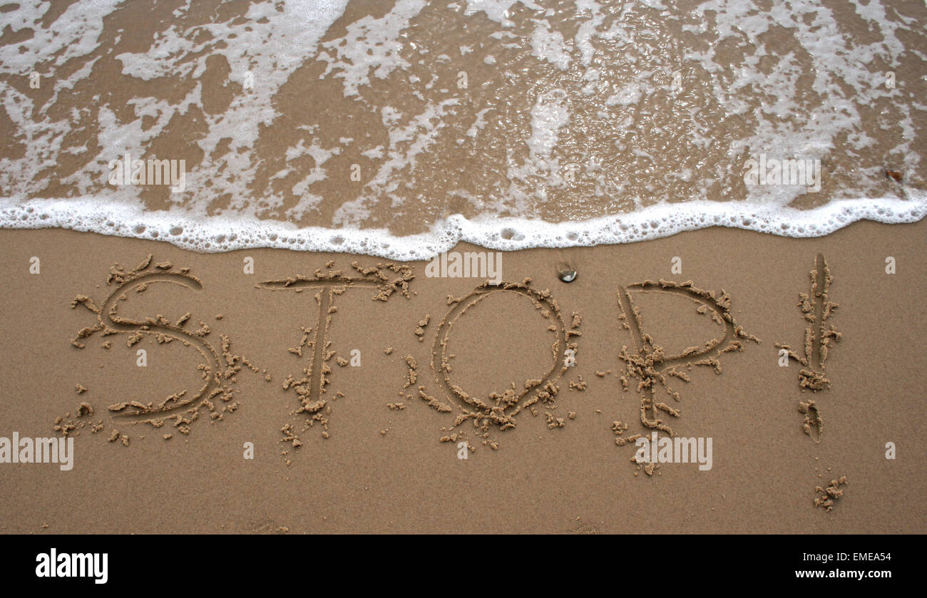 The word STOP written in sand next to the shore Stock Photo - Alamy