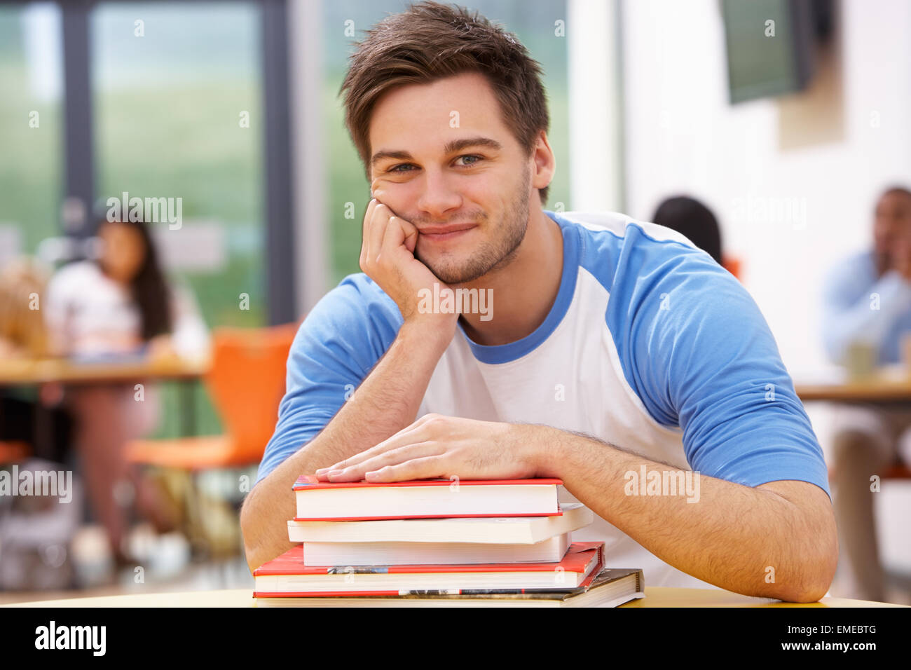 Male Student Studying In Classroom With Books Stock Photo - Alamy