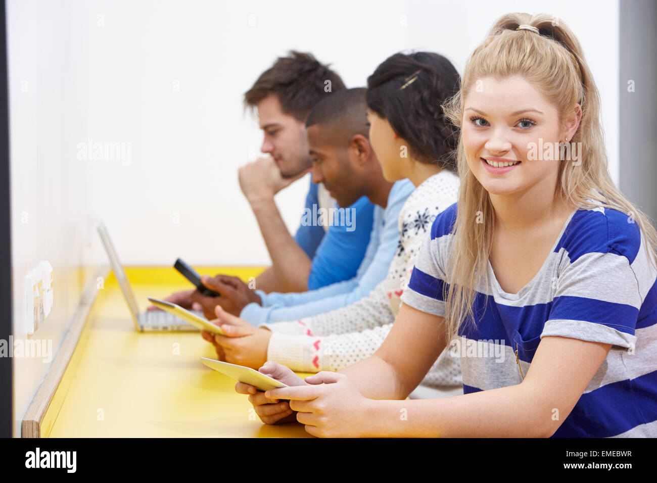 Group Of College Students Using Digital Devices Stock Photo - Alamy