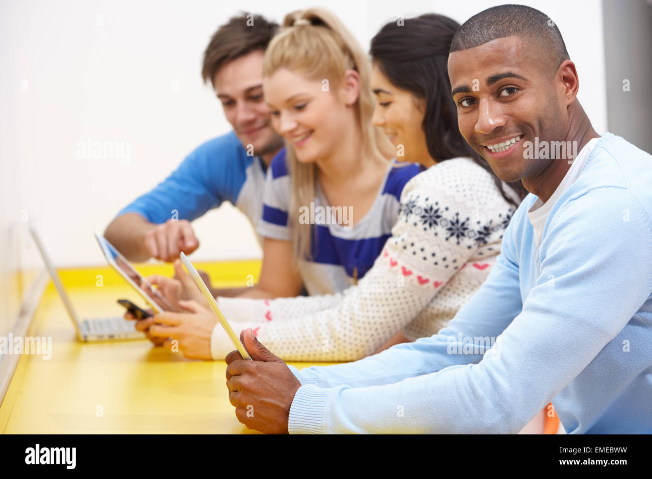Group Of College Students Using Digital Devices Stock Photo - Alamy