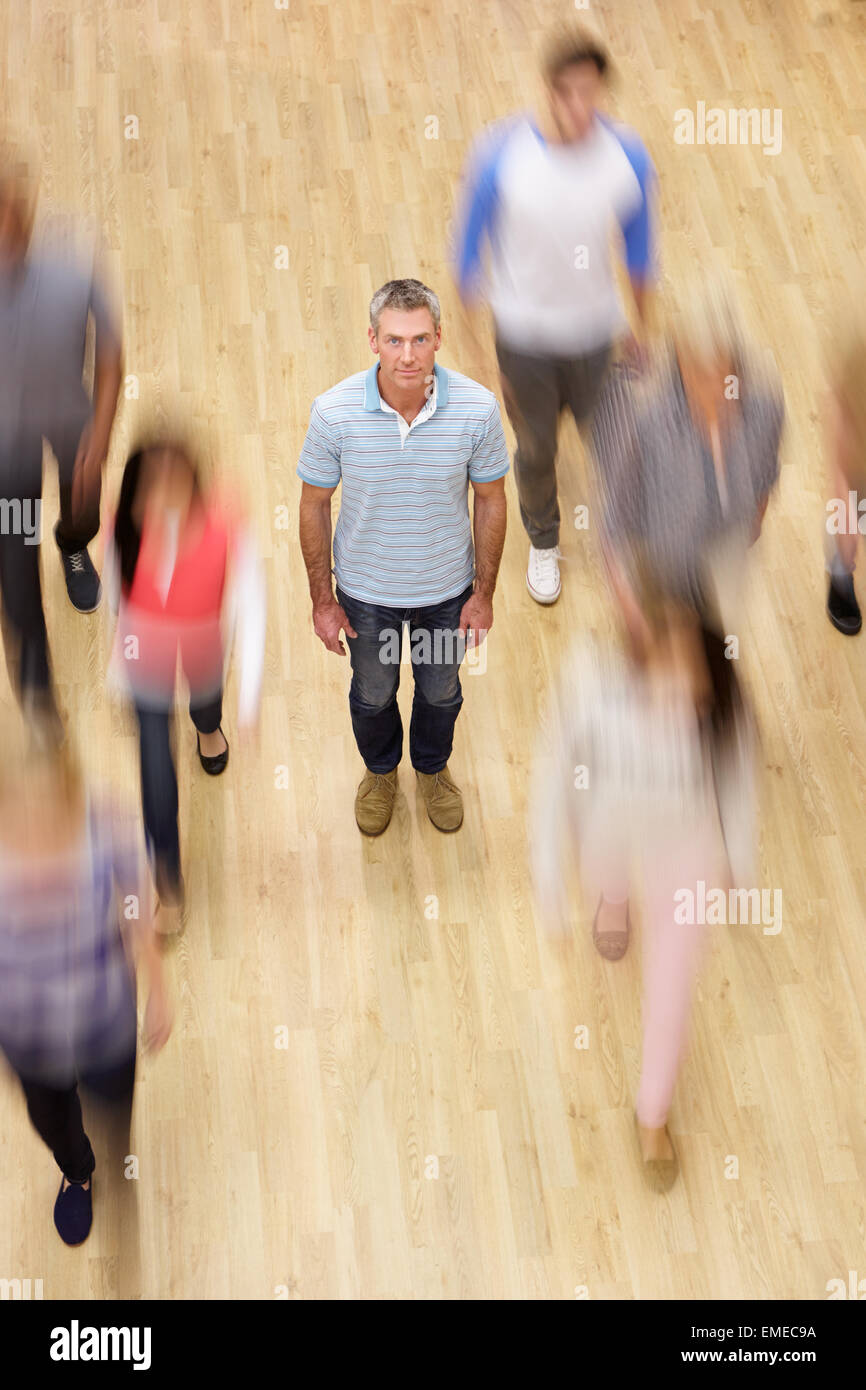 Overhead View Of Man Surrounded By Blurred Figures Stock Photo - Alamy