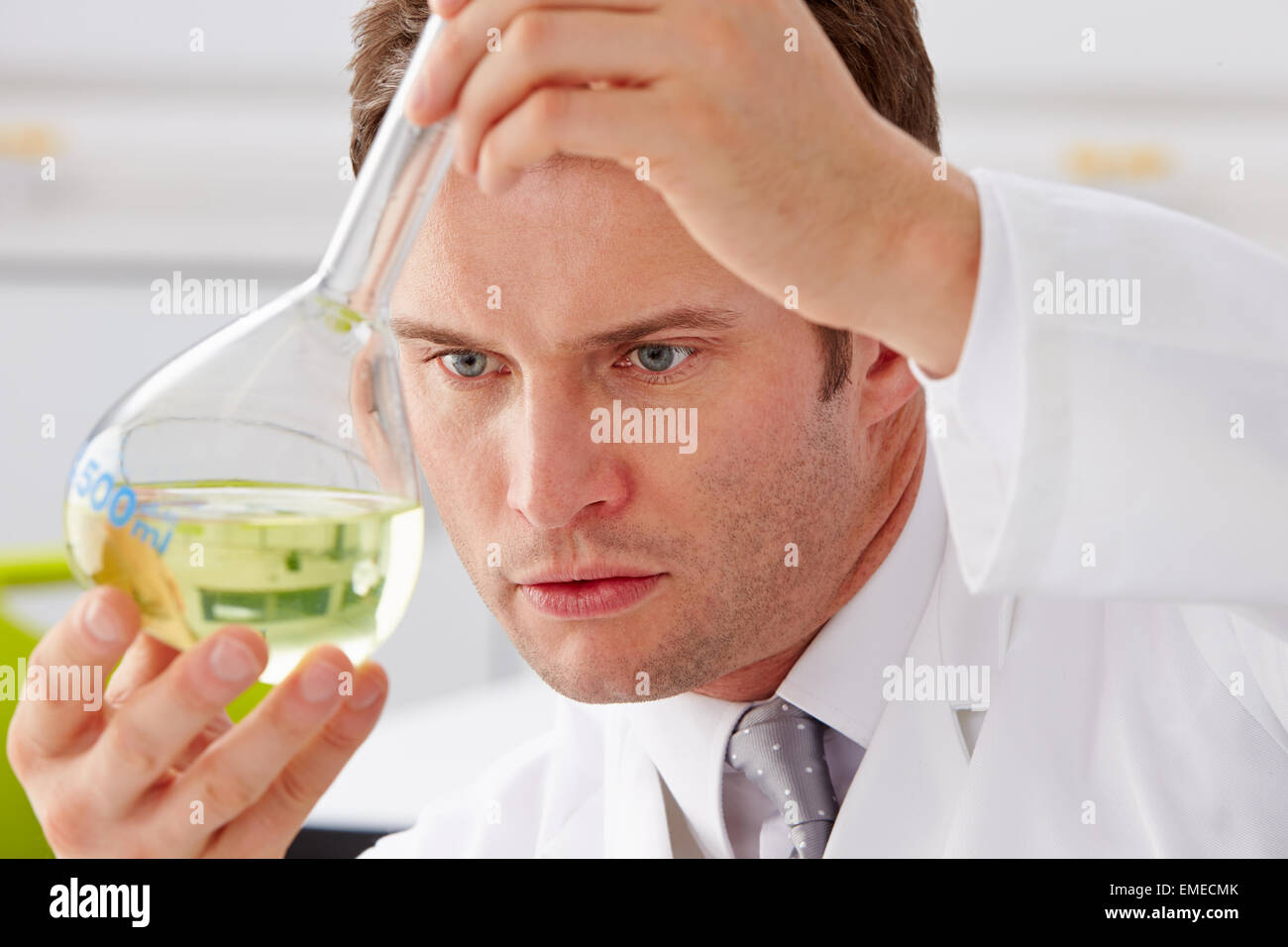 Scientist Studying Liquid In Flask Stock Photo - Alamy