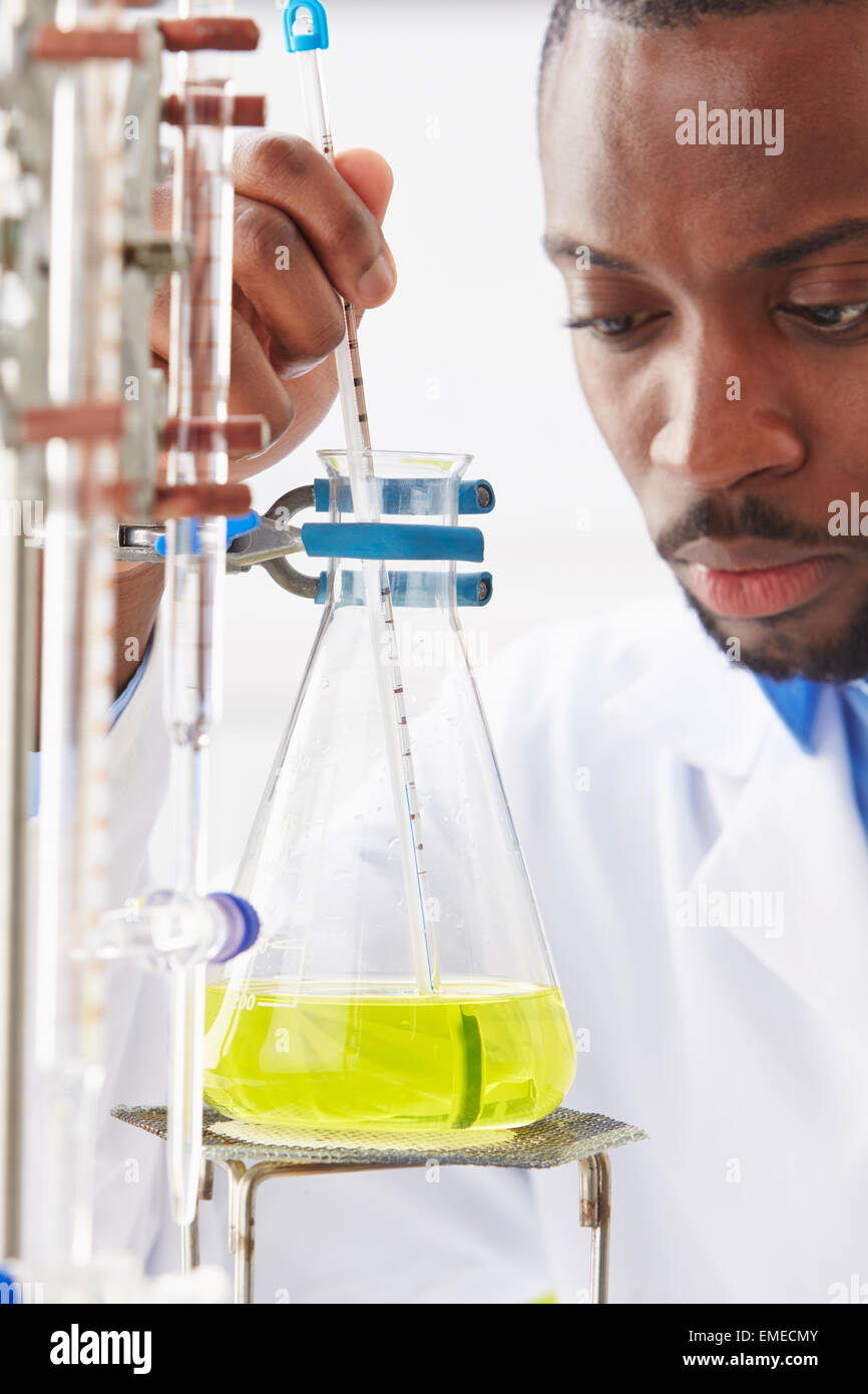 Scientist Studying Liquid In Flask Stock Photo - Alamy