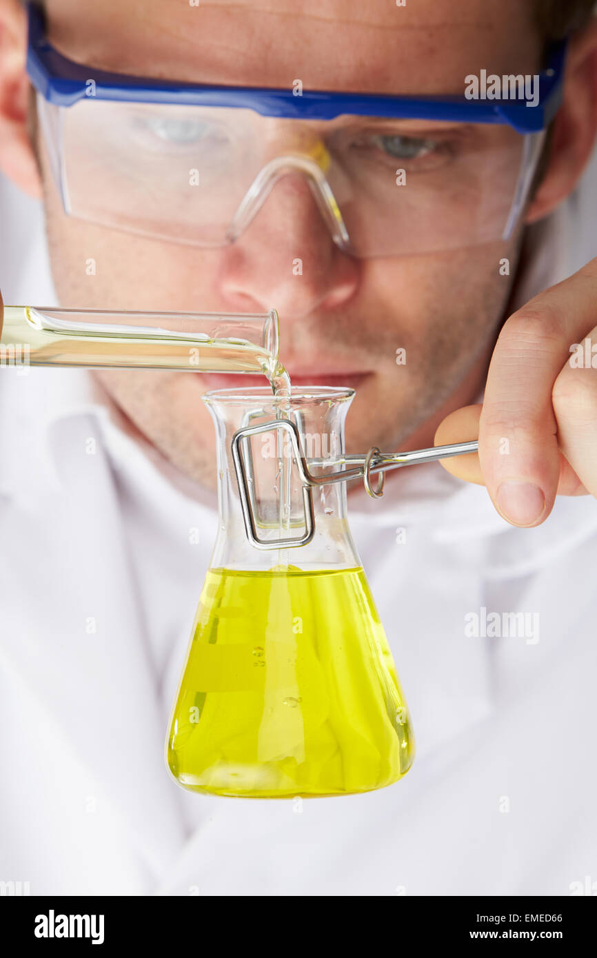 Scientist Pouring Liquid From Test Tube Into Flask Stock Photo - Alamy Scientist Pouring Liquid From Test Tube Into Flask Stock Photo - Alamy