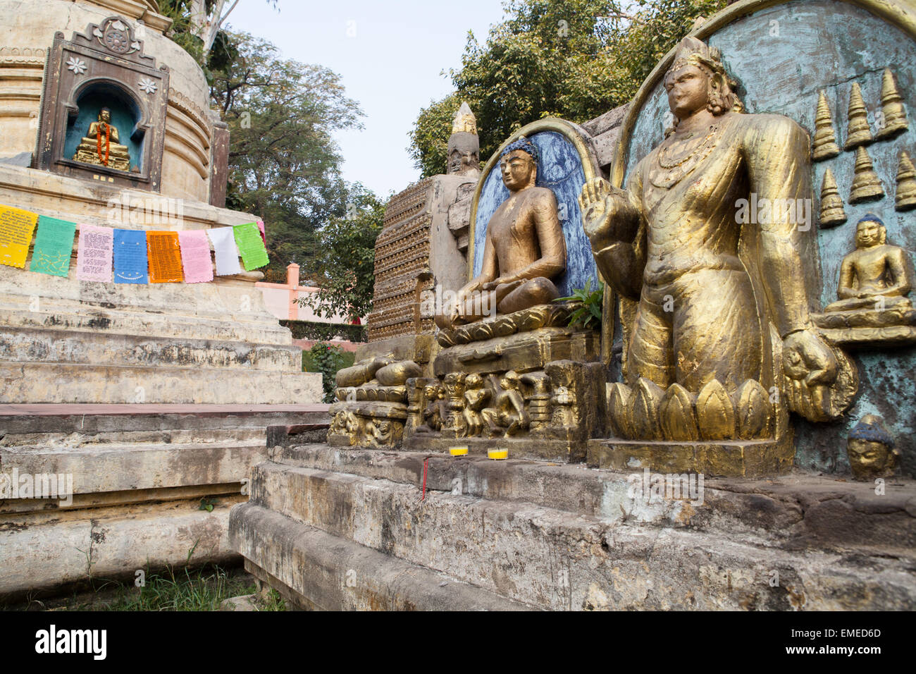 Statues of the Buddha with stupa and prayer flags at the Mahabodhi ...