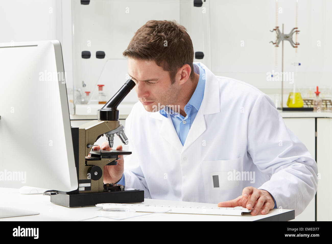 Scientist Looking Through Microscope In Laboratory Stock Photo - Alamy