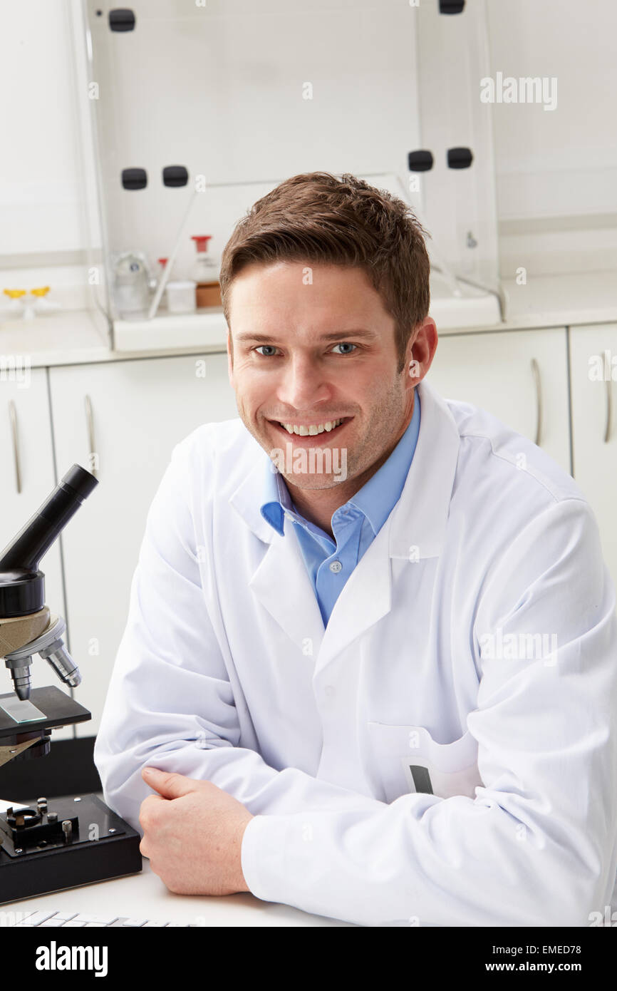 Portrait Of Scientist With Microscope In Laboratory Stock Photo - Alamy