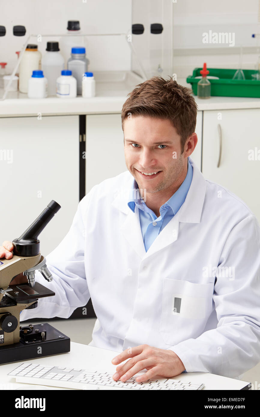 Portrait Of Scientist With Microscope In Laboratory Stock Photo - Alamy