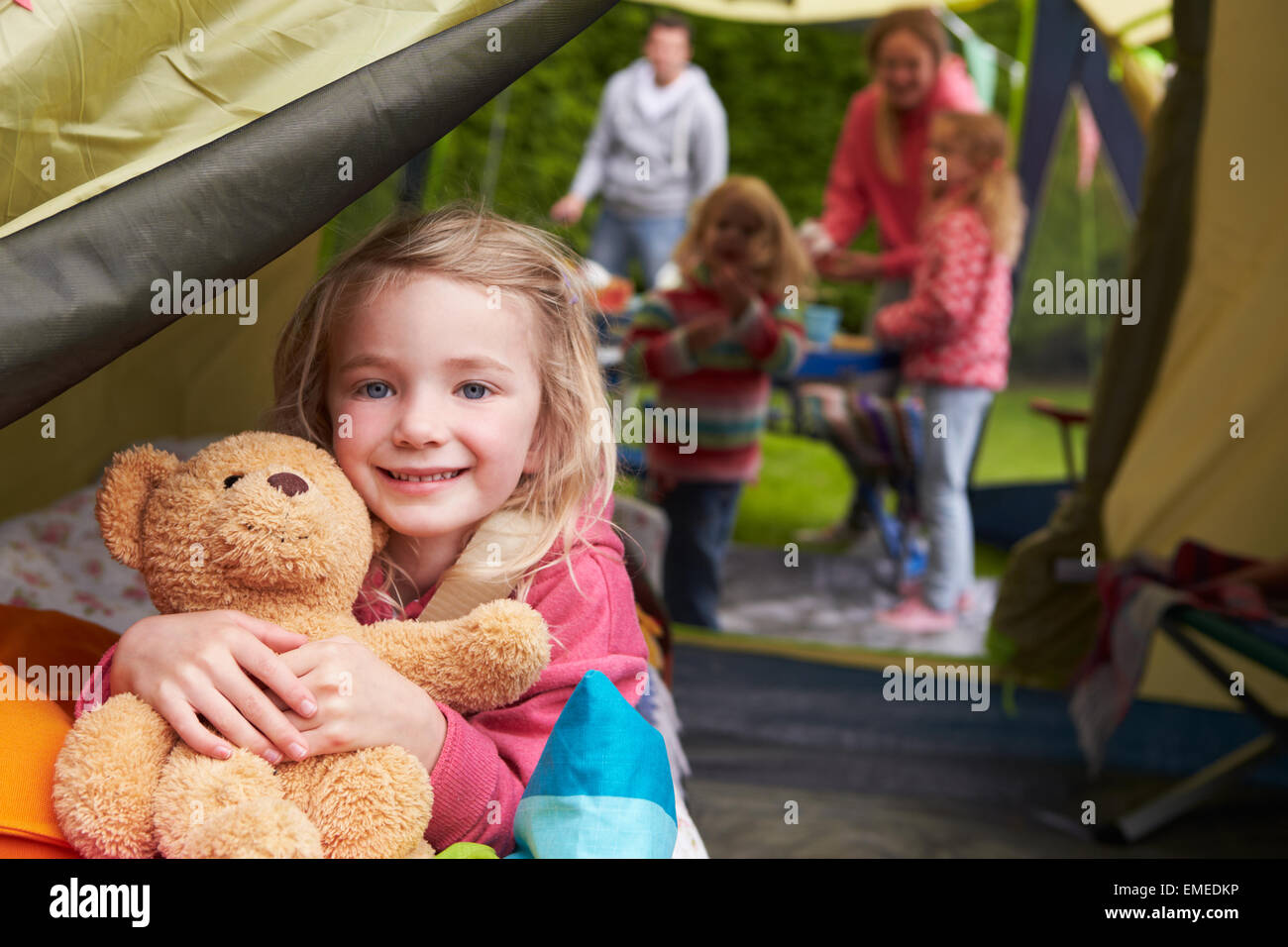 Girl With Teddy Bear Enjoying Camping Holiday On Campsite Stock Photo ...