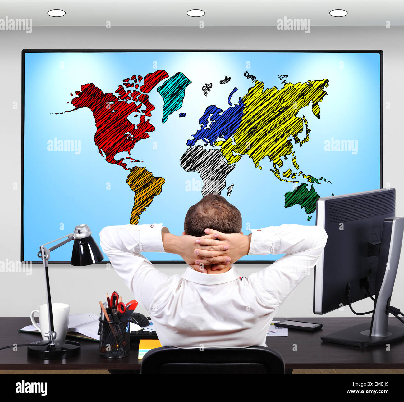 businessman sitting in office and looking to world map Stock Photo - Alamy
