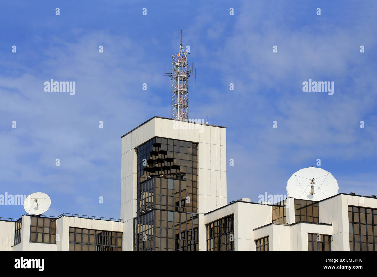Top of the tech building with glass walls and radio equipment on the ...