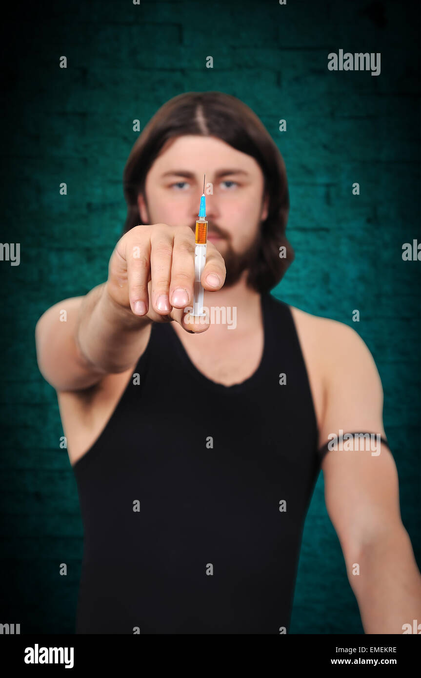 drug addict with syringe on blue background Stock Photo - Alamy
