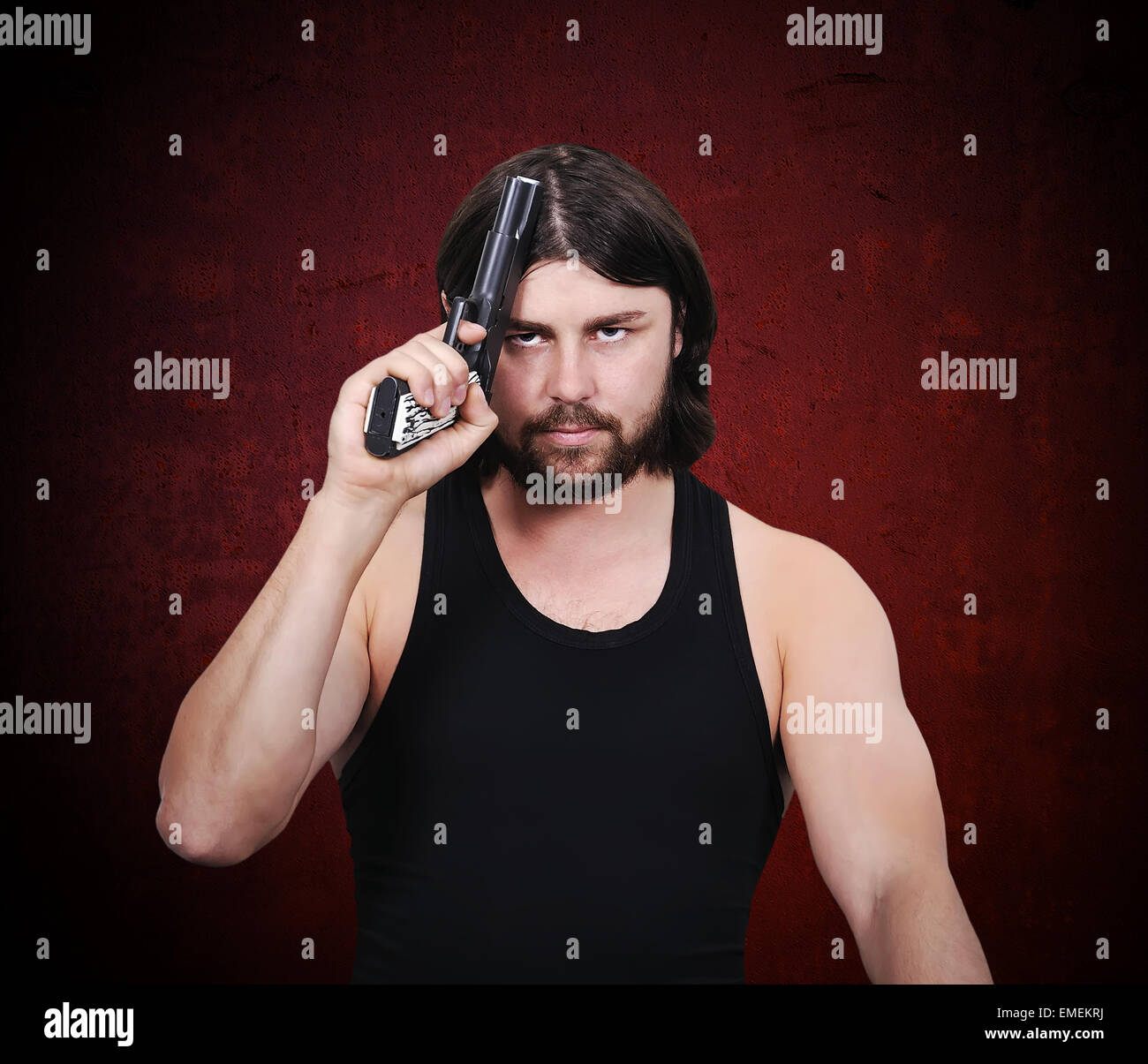 killer man with gun on red background Stock Photo - Alamy