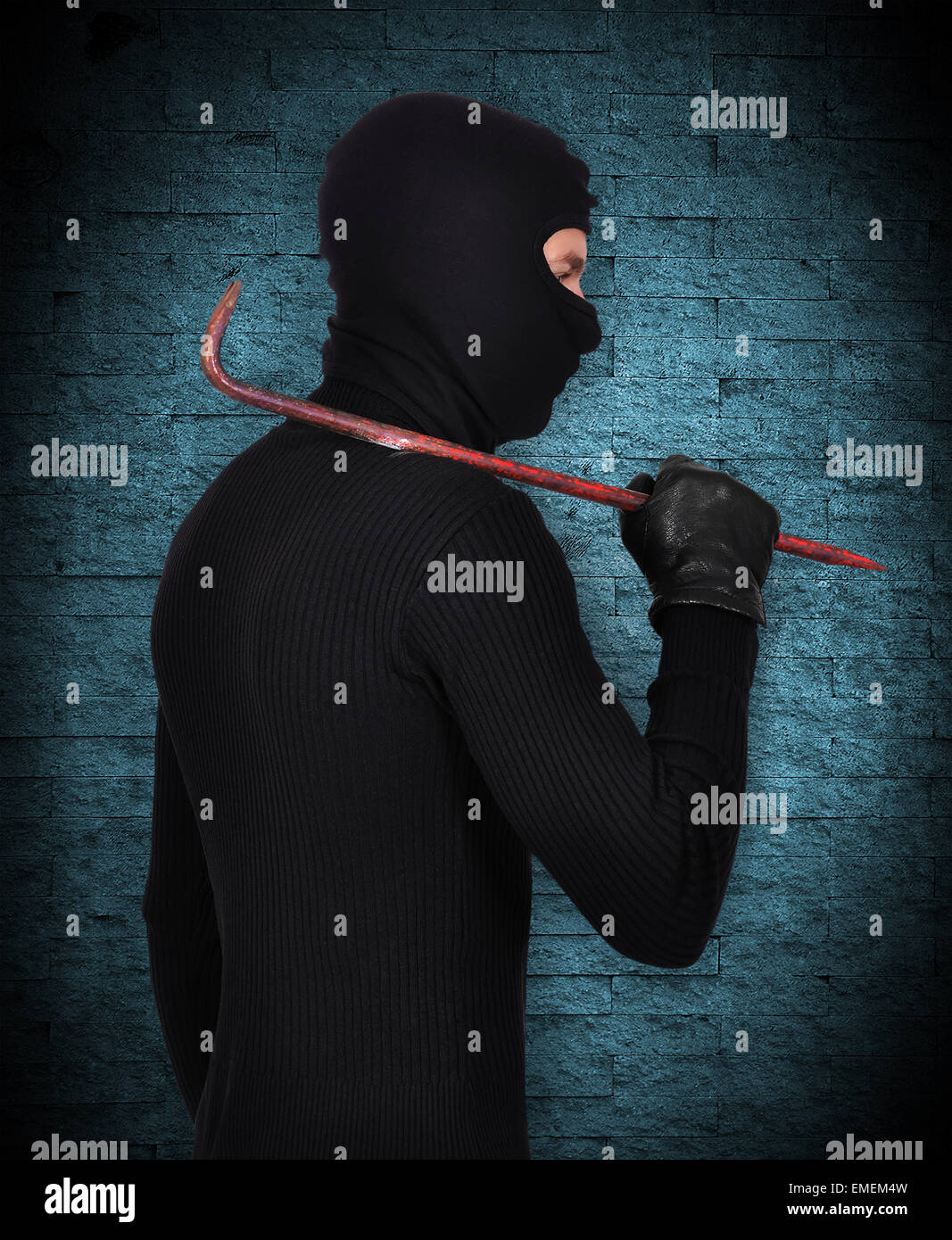 mugger in mask with nail puller on gray background Stock Photo - Alamy