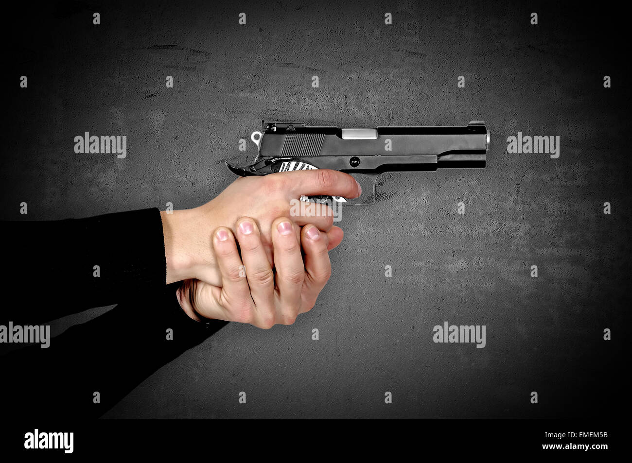 gun in hands on a black background Stock Photo - Alamy