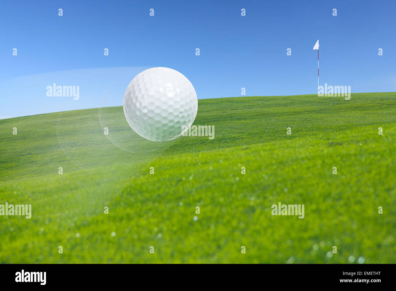 Close-up of flying golf ball over beautiful golf course Stock Photo - Alamy