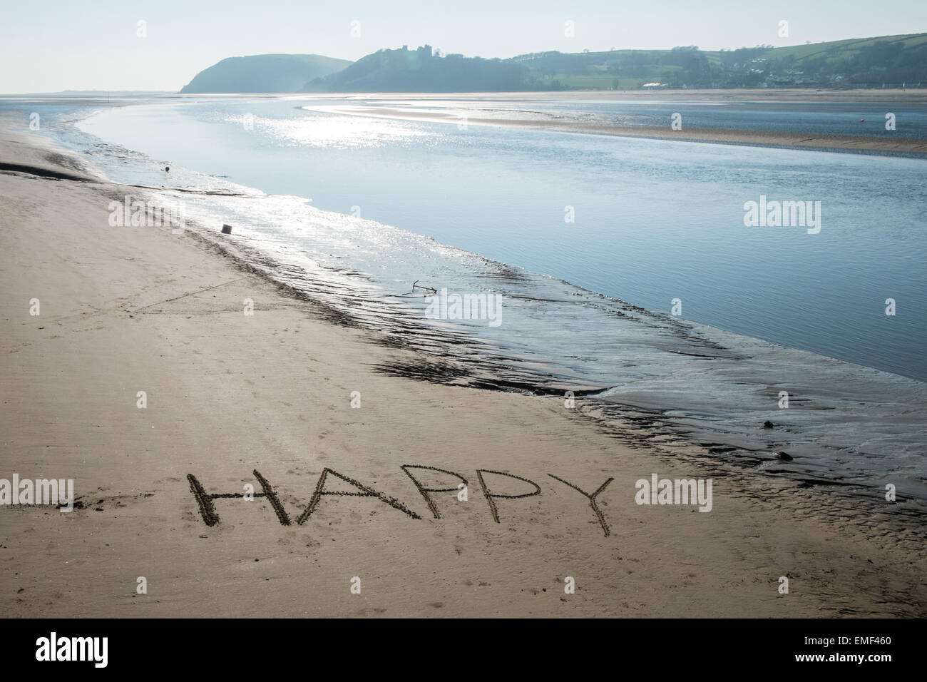 "Happy" written in the sands on the beach at Ferryside with Llanstephan ...