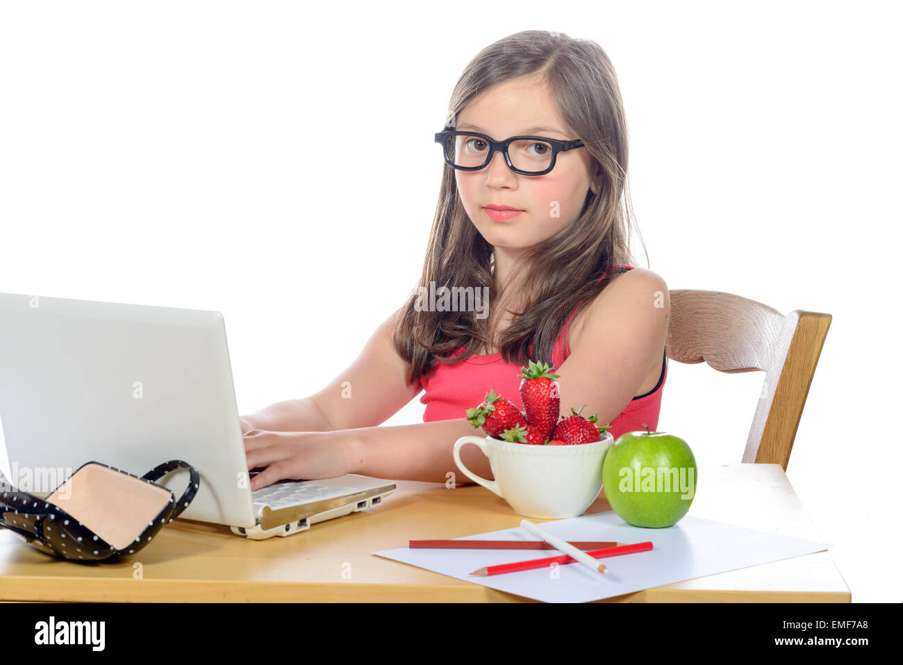 a little girl doing her homework on her computer on white Stock Photo ...