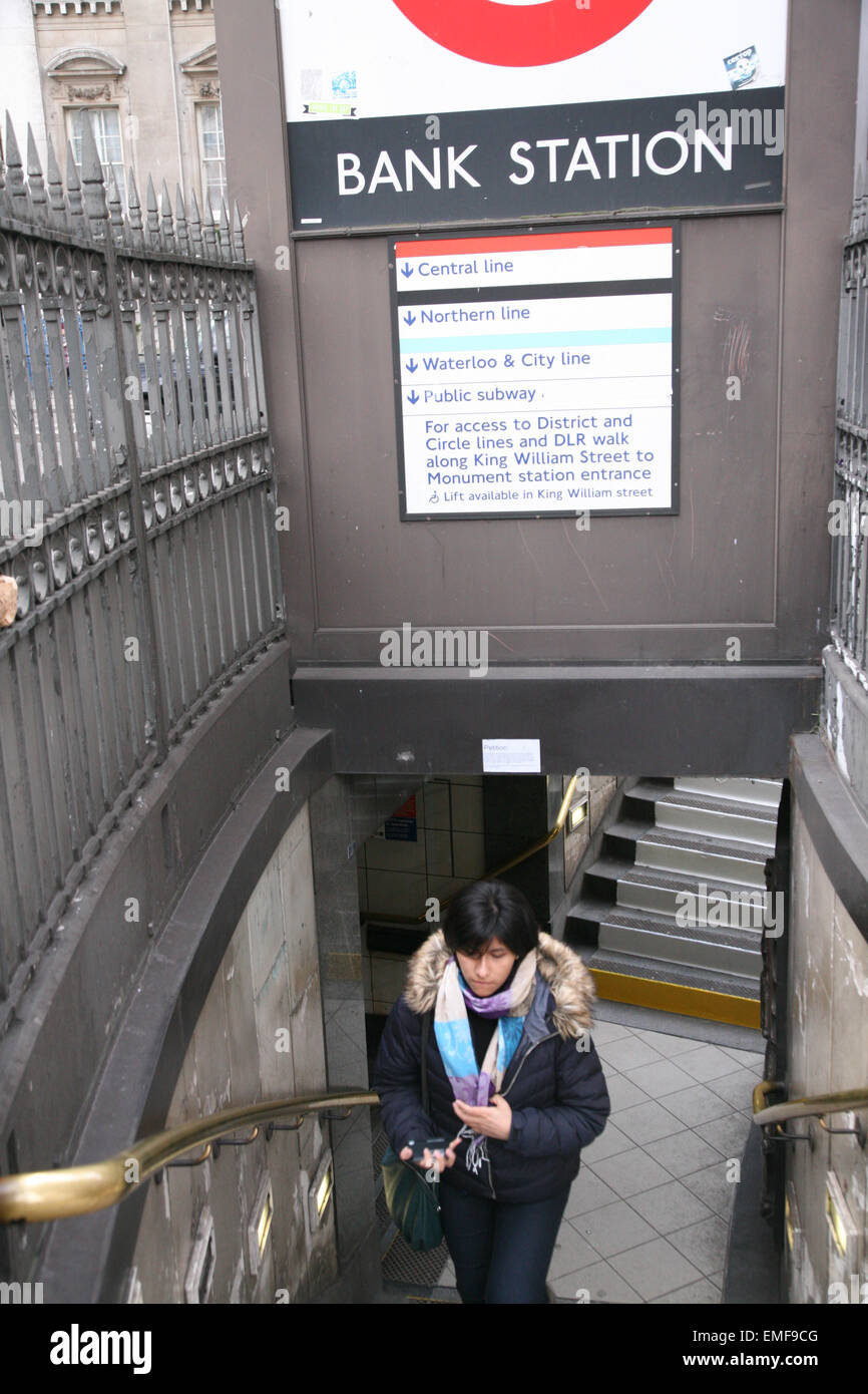 Woman climbing up the steps during Winter, at Bank Underground Station ...