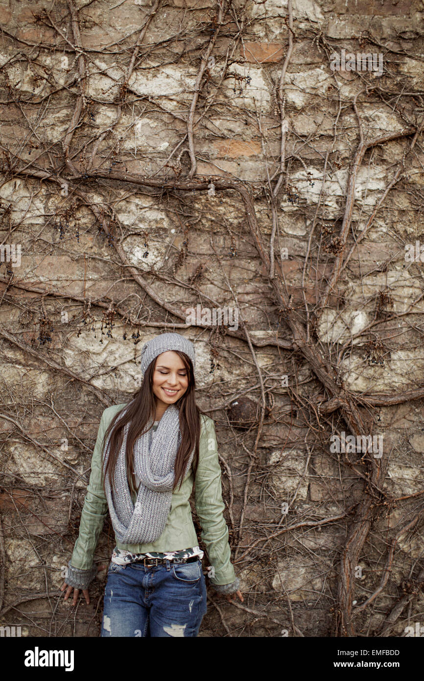 Young woman by the wall at autumn Stock Photo - Alamy