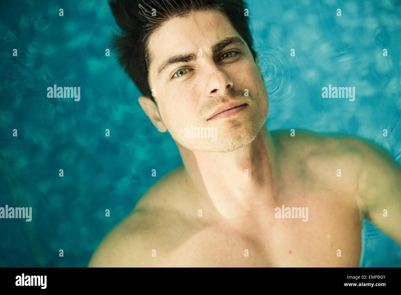Young man floating in the swimming pool Stock Photo - Alamy