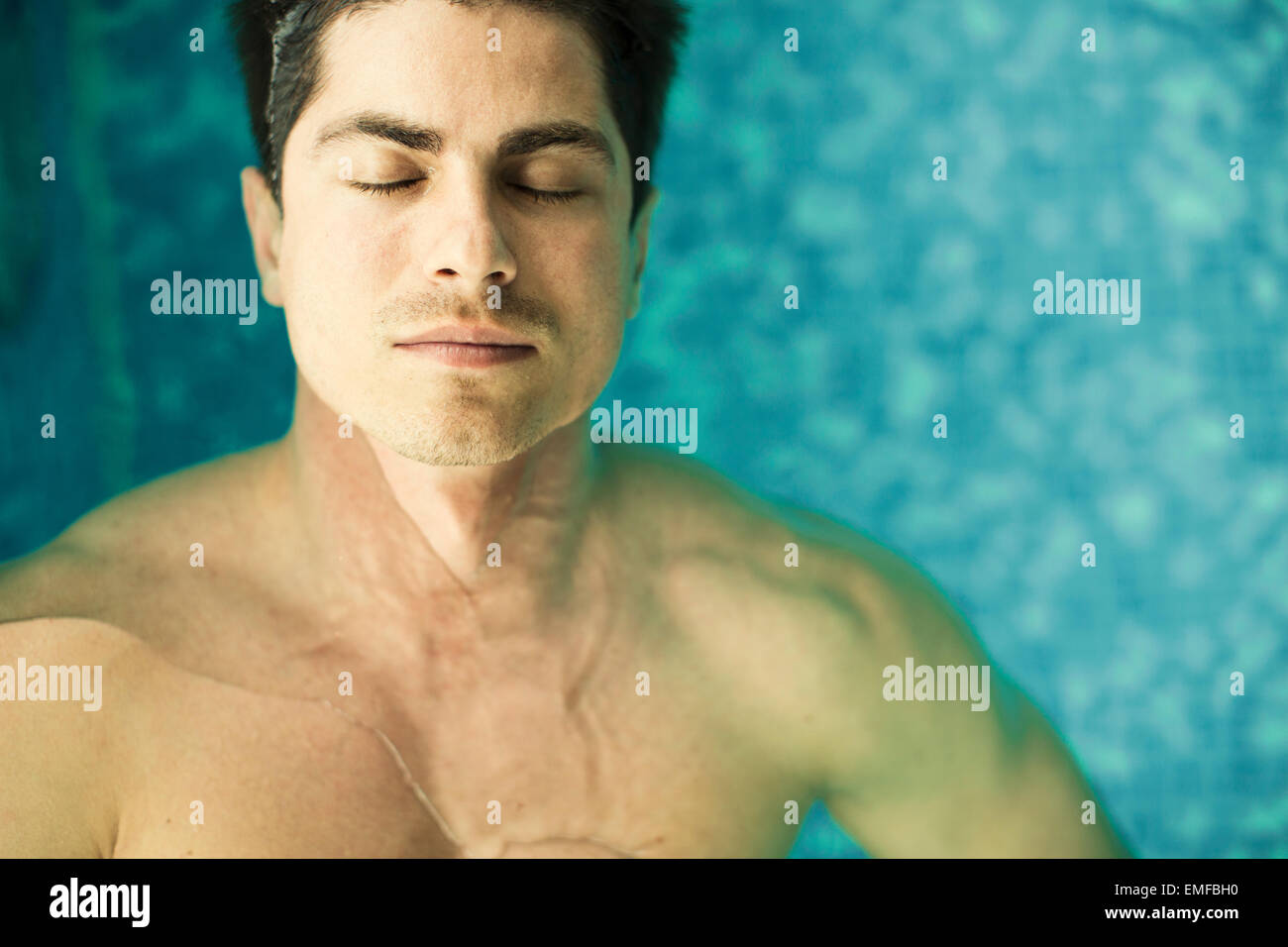 Handsome man floating in pool hi-res stock photography and images - Alamy