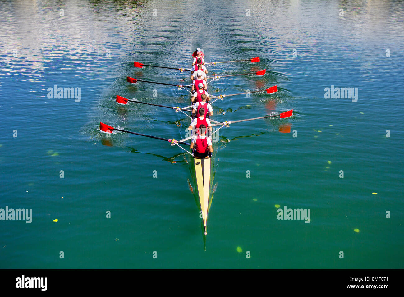 Boat coxed eight Rowers rowing on the blue lake Stock Photo - Alamy