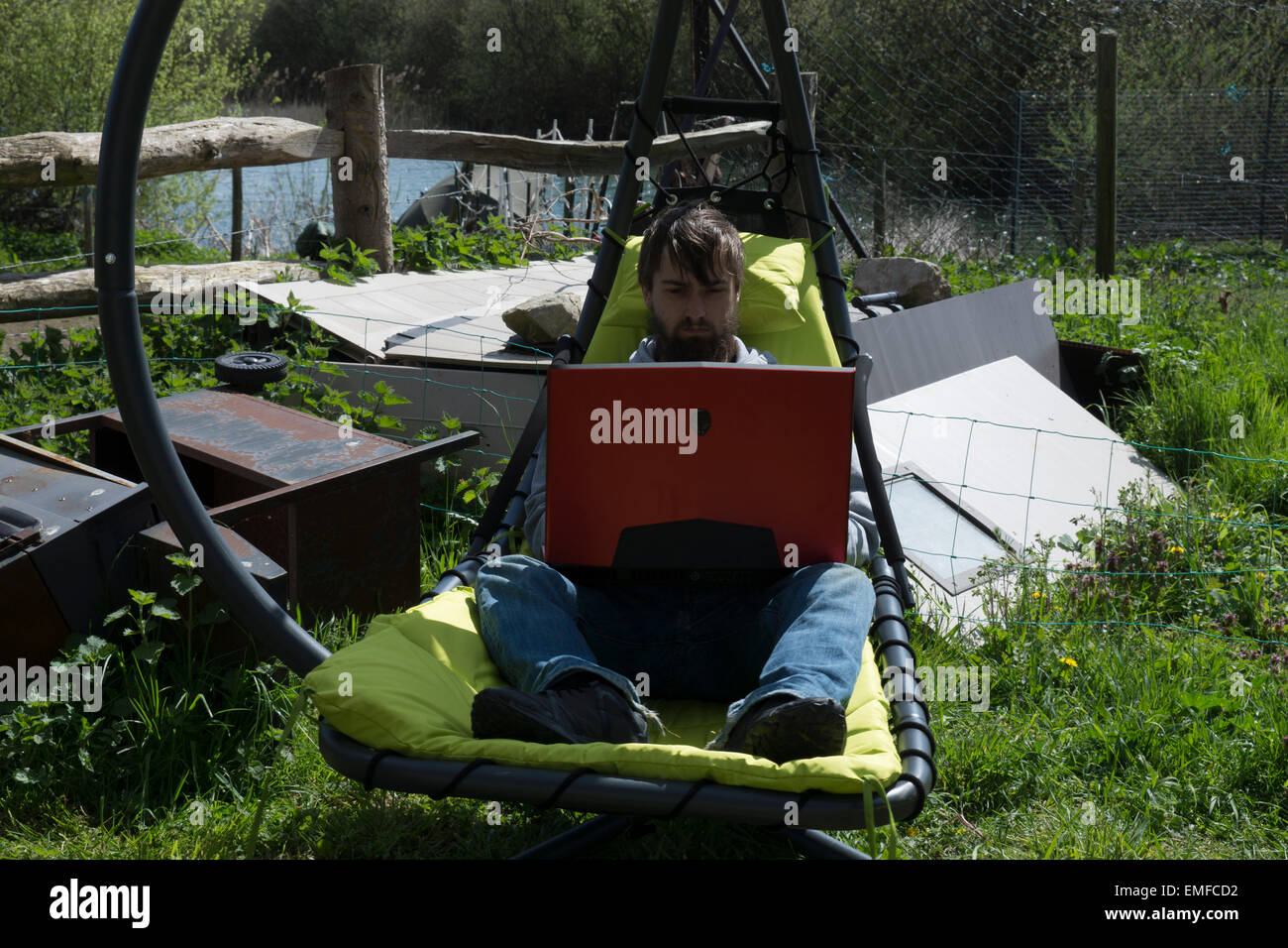 Young male, is relaxing outside in the garden. Doing revision and ...
