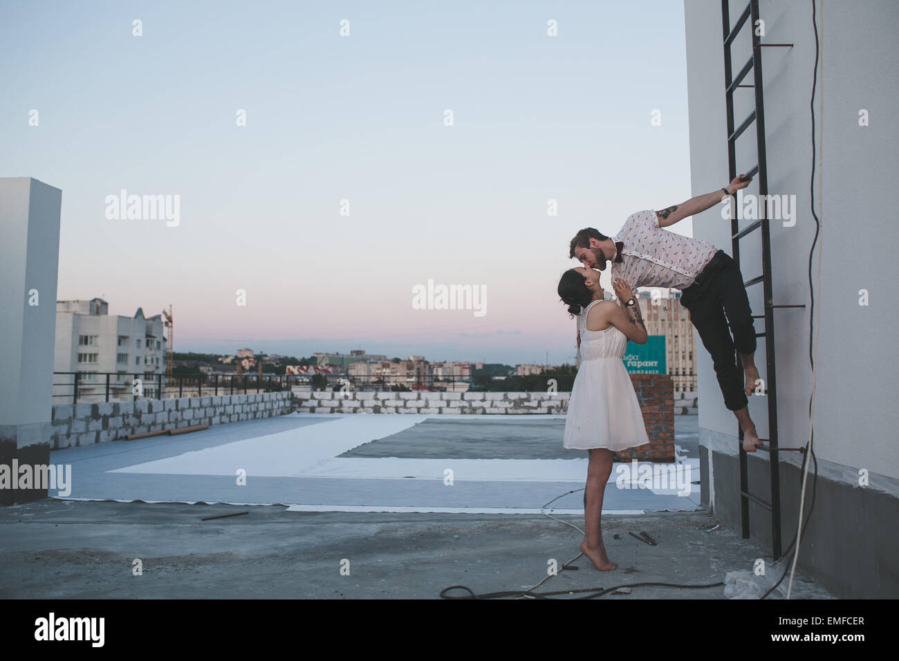 beautiful couple together on the roof of a tall building Stock Photo ...