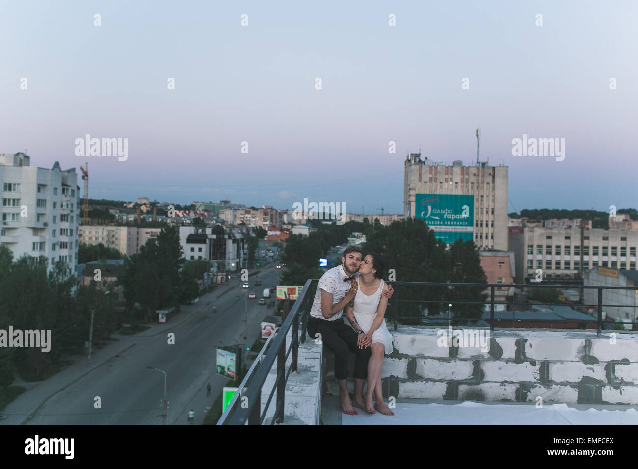 beautiful couple together on the roof of a tall building Stock Photo ...