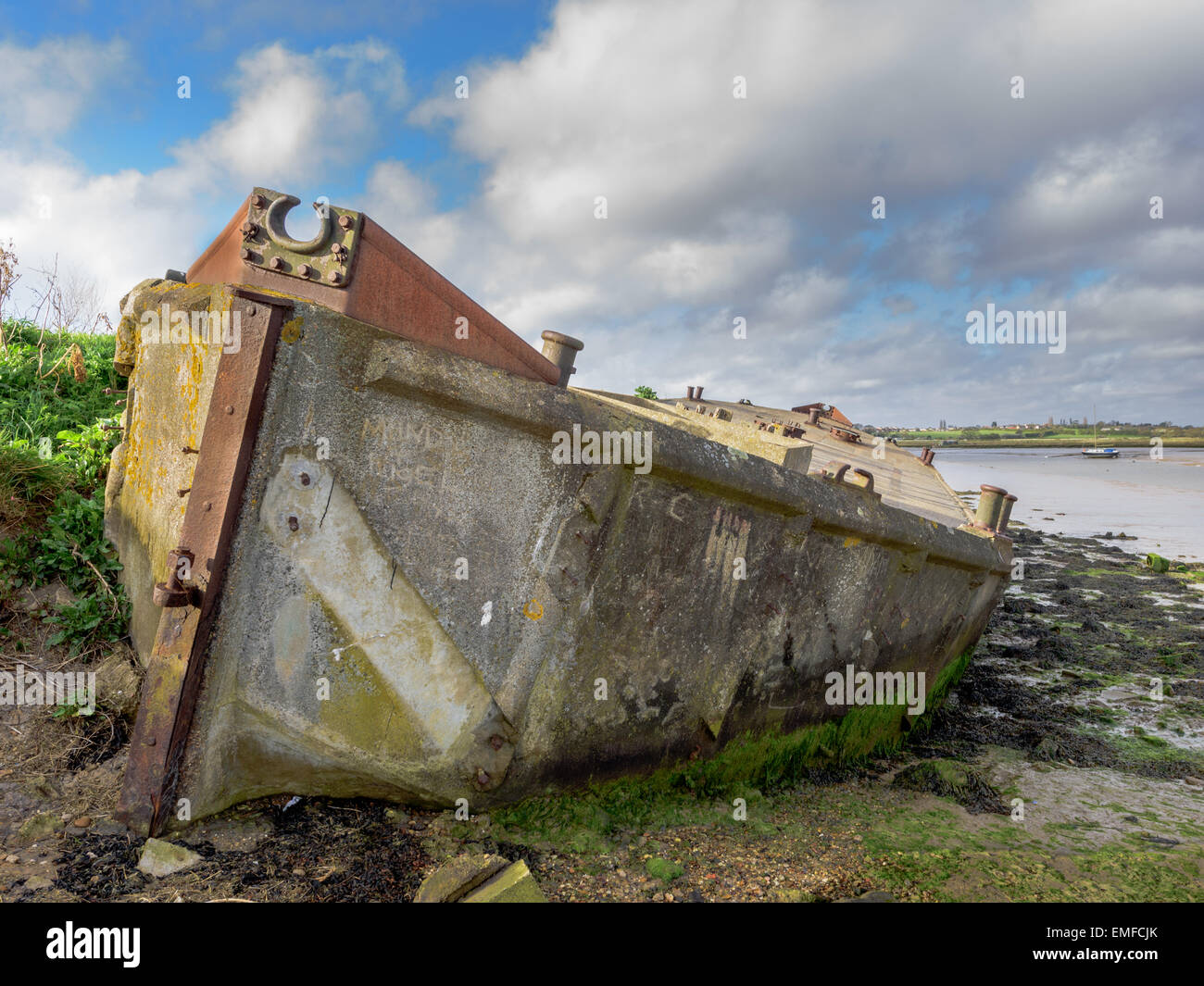 A lonely stranded old concrete barge abandoned by the side of the ...