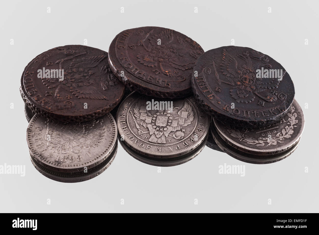 silver and copper coins with double headed eagle on the gray background ...