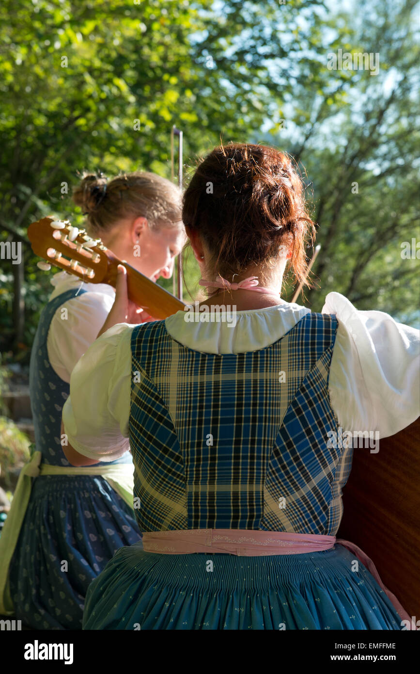 two girls in traditional costumes playing music, Altaussee, Styria ...