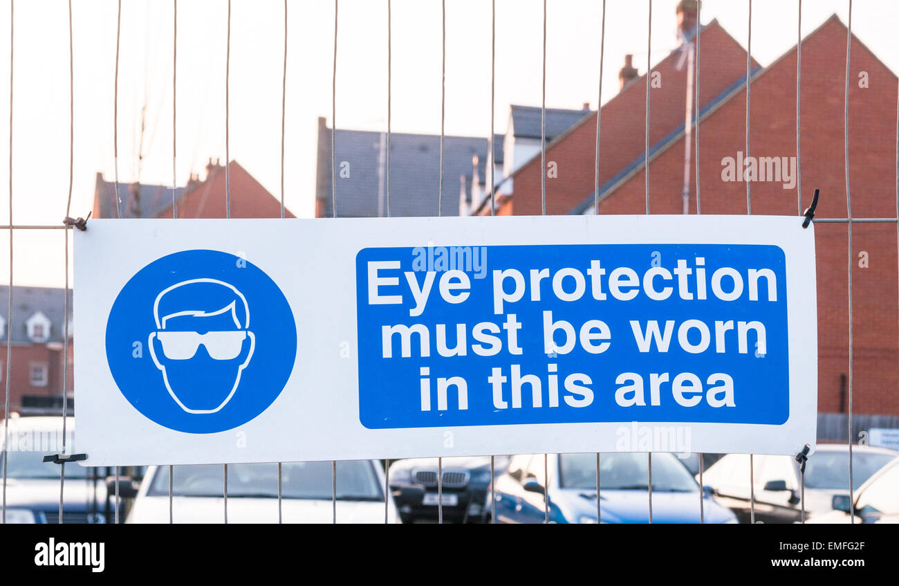 Warning sign attached to metal fence on a construction site Stock Photo ...