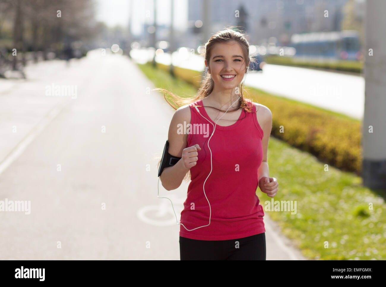 Young beautiful woman running in the city Stock Photo - Alamy