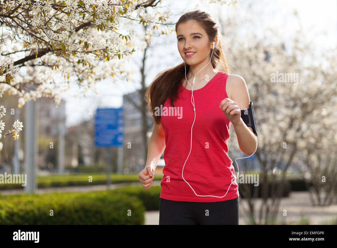 Young beautiful woman running in the city Stock Photo - Alamy