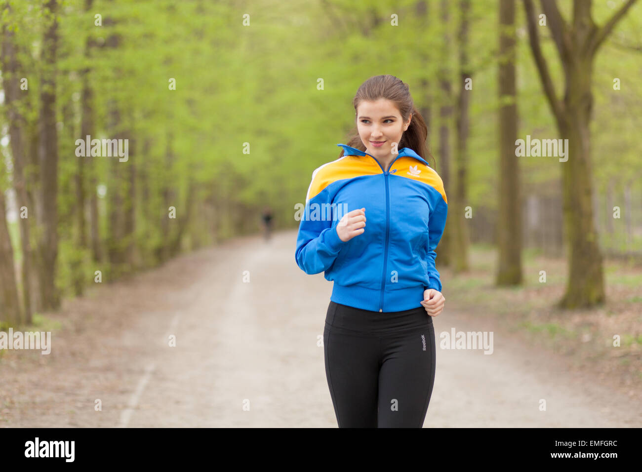 Young beautiful woman running on a trail Stock Photo - Alamy