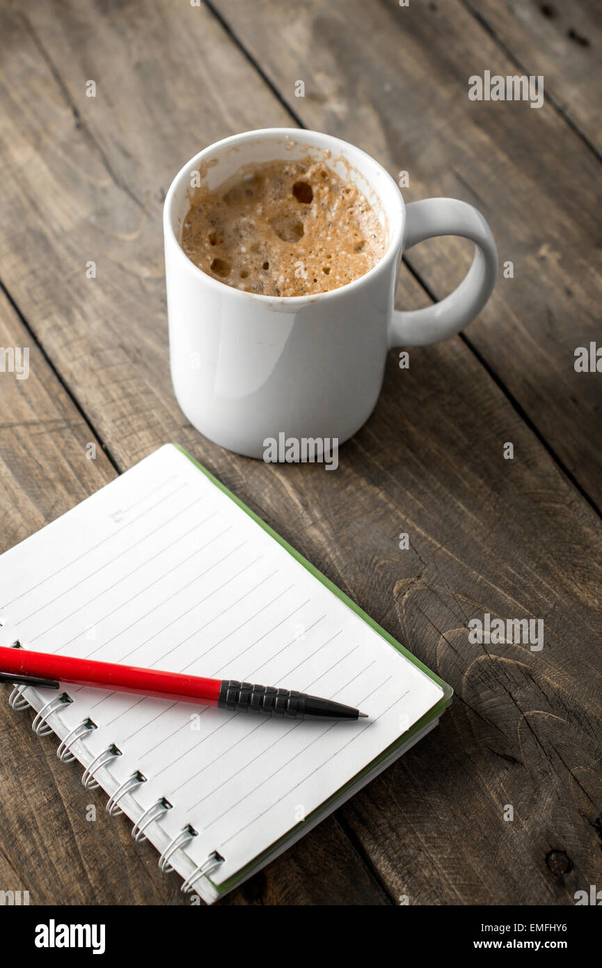 coffee and notebook on working desk, close up Stock Photo - Alamy
