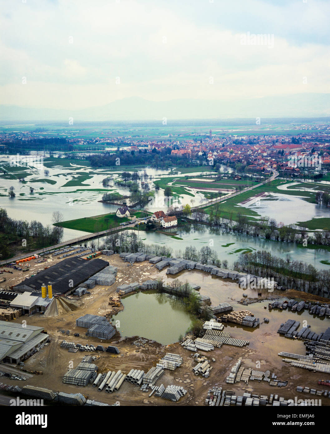 Aerial view of flooded industrial estate and fields and Benfeld village ...