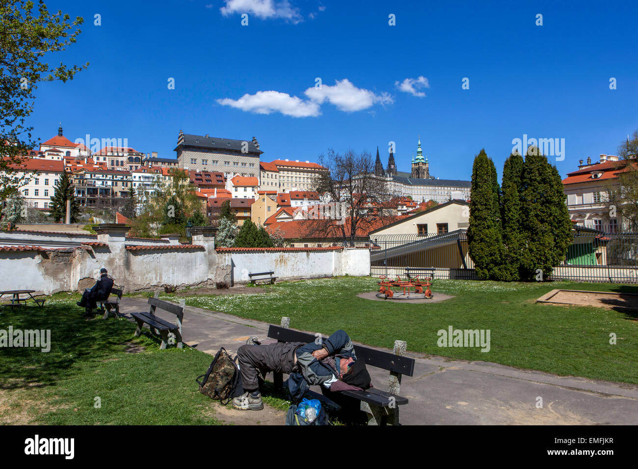 Homeless people resting in a park. View of Prague Castle Hradcany Czech ...