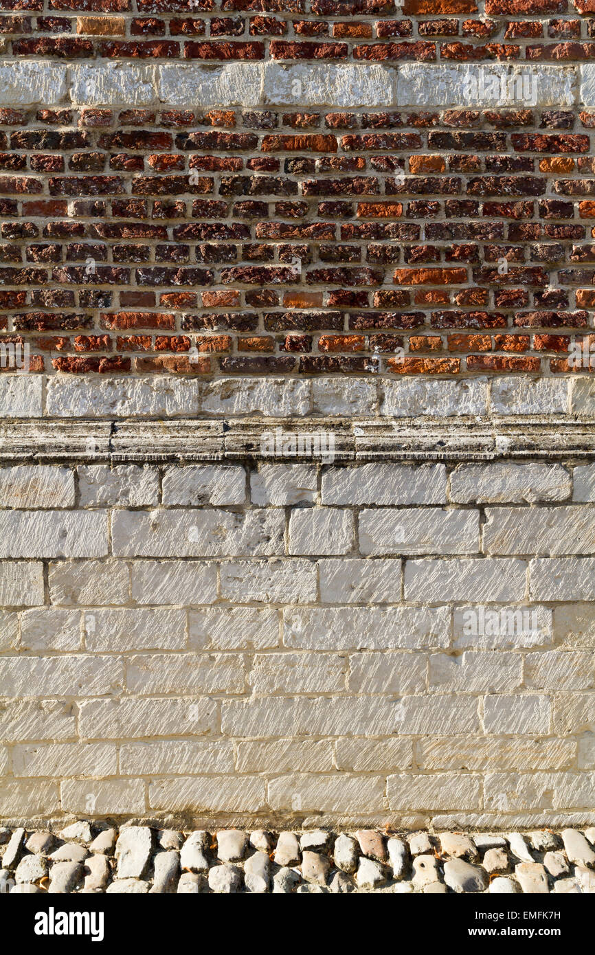 Textured red and beige brick wall using different types of brick to ...