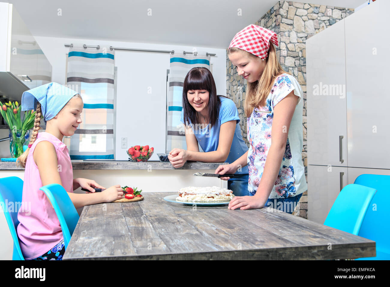Mother with daughters baking a pie at home Stock Photo - Alamy