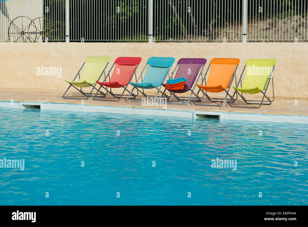 Row colorful chairs at the swimming pool Stock Photo - Alamy